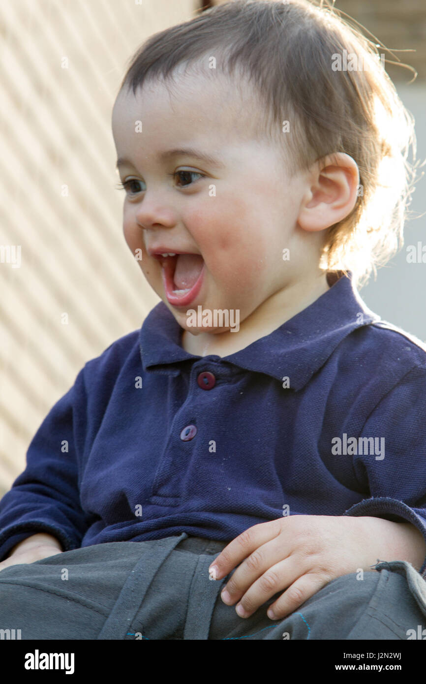 Laughing baby in the sun boy photo Stock Photo - Alamy