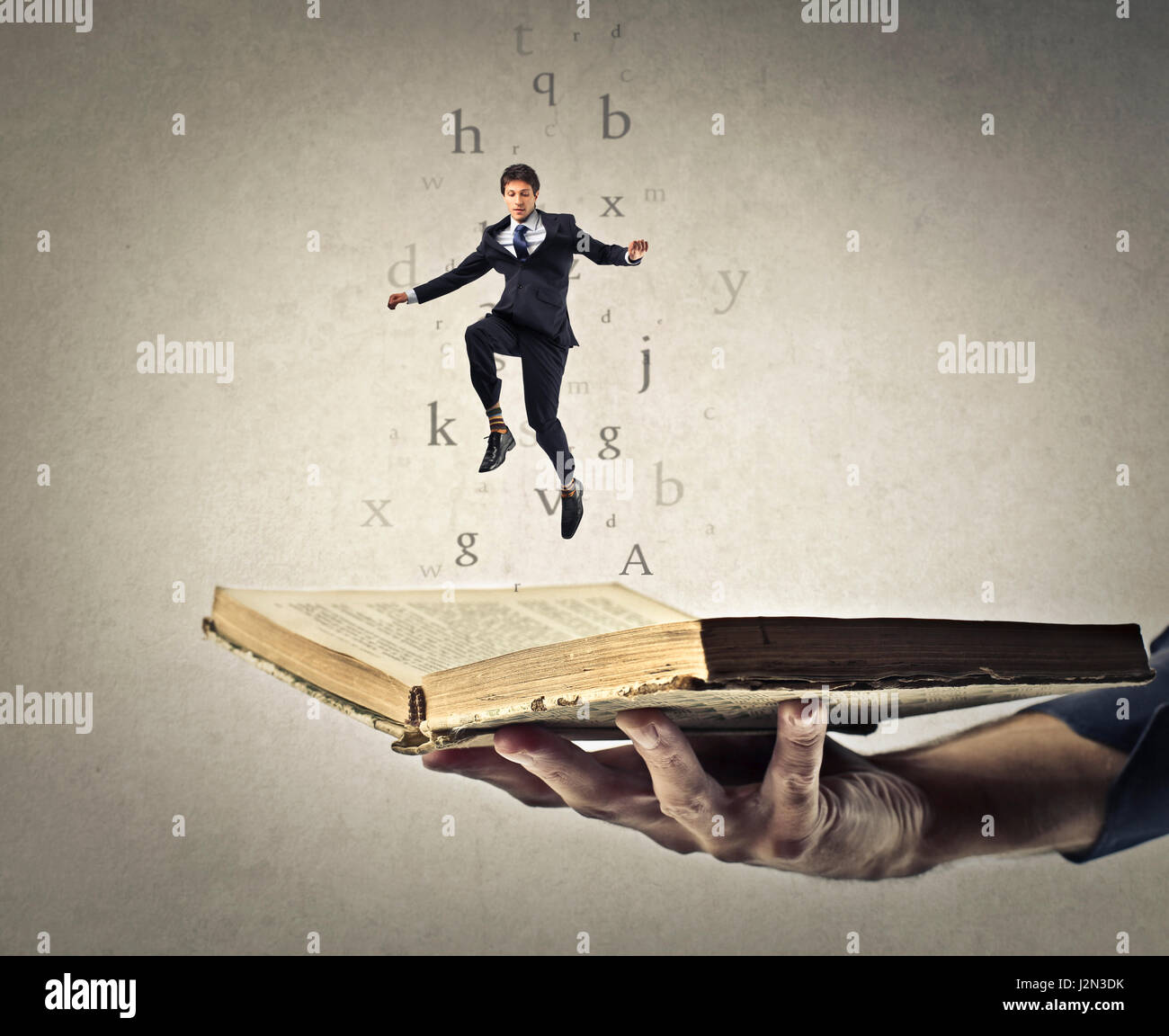 Businessman jumping out of book Stock Photo - Alamy