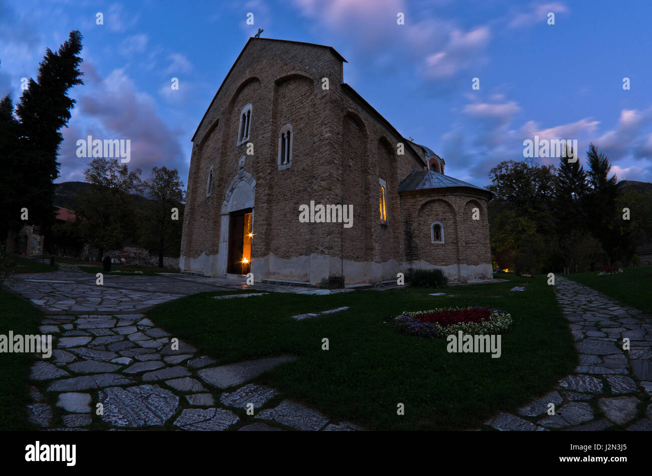 Church inside 12.century Studenica monastery during evening prayer ...