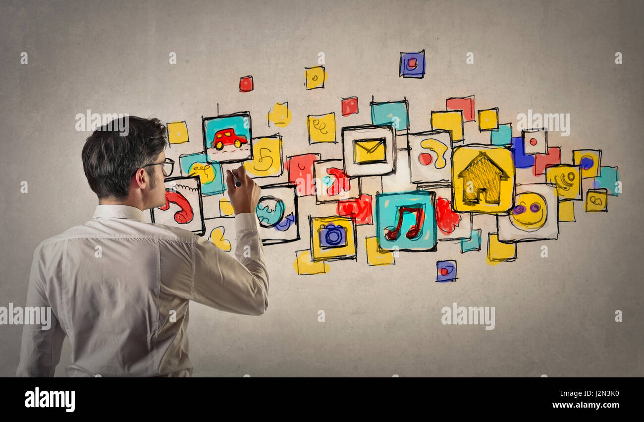 Man drawing icons on wall Stock Photo - Alamy