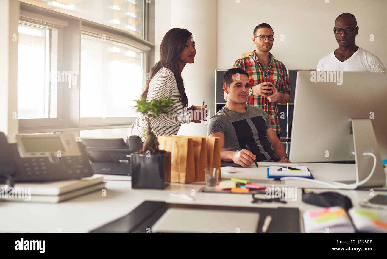The people in the office looking at the computer screen Stock Photo - Alamy