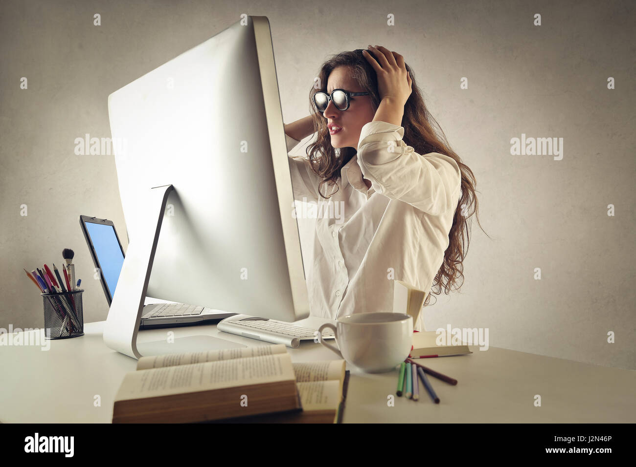 Stressed business women in front of computer Stock Photo - Alamy