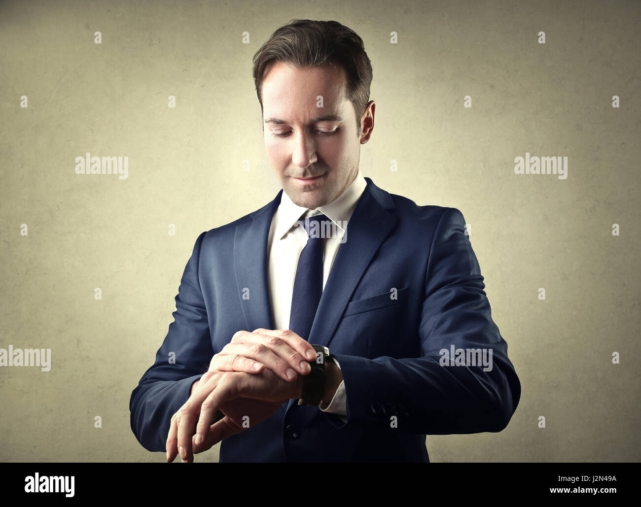 Businessman checking the time Stock Photo - Alamy