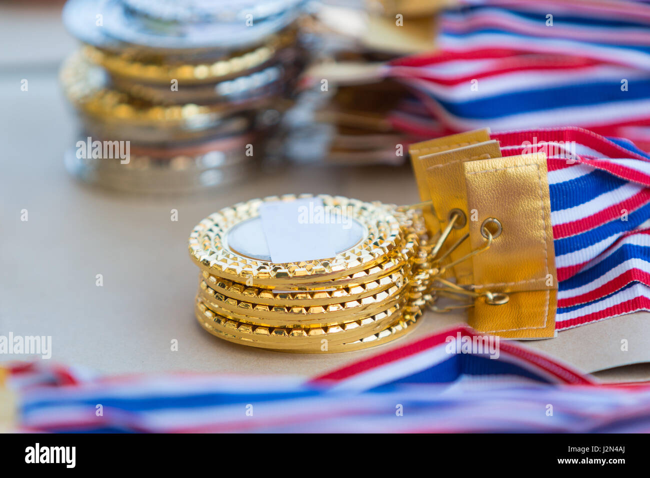 stacks of gold, silver, and bronze medals, selective focus on the ...