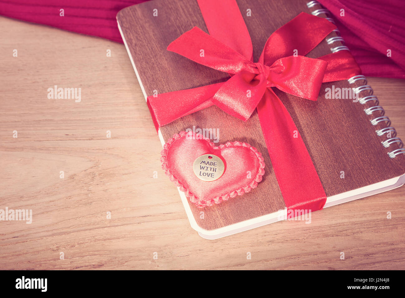 notebook wrapped with red ribbon, red felt hearts in vintage pink color ...