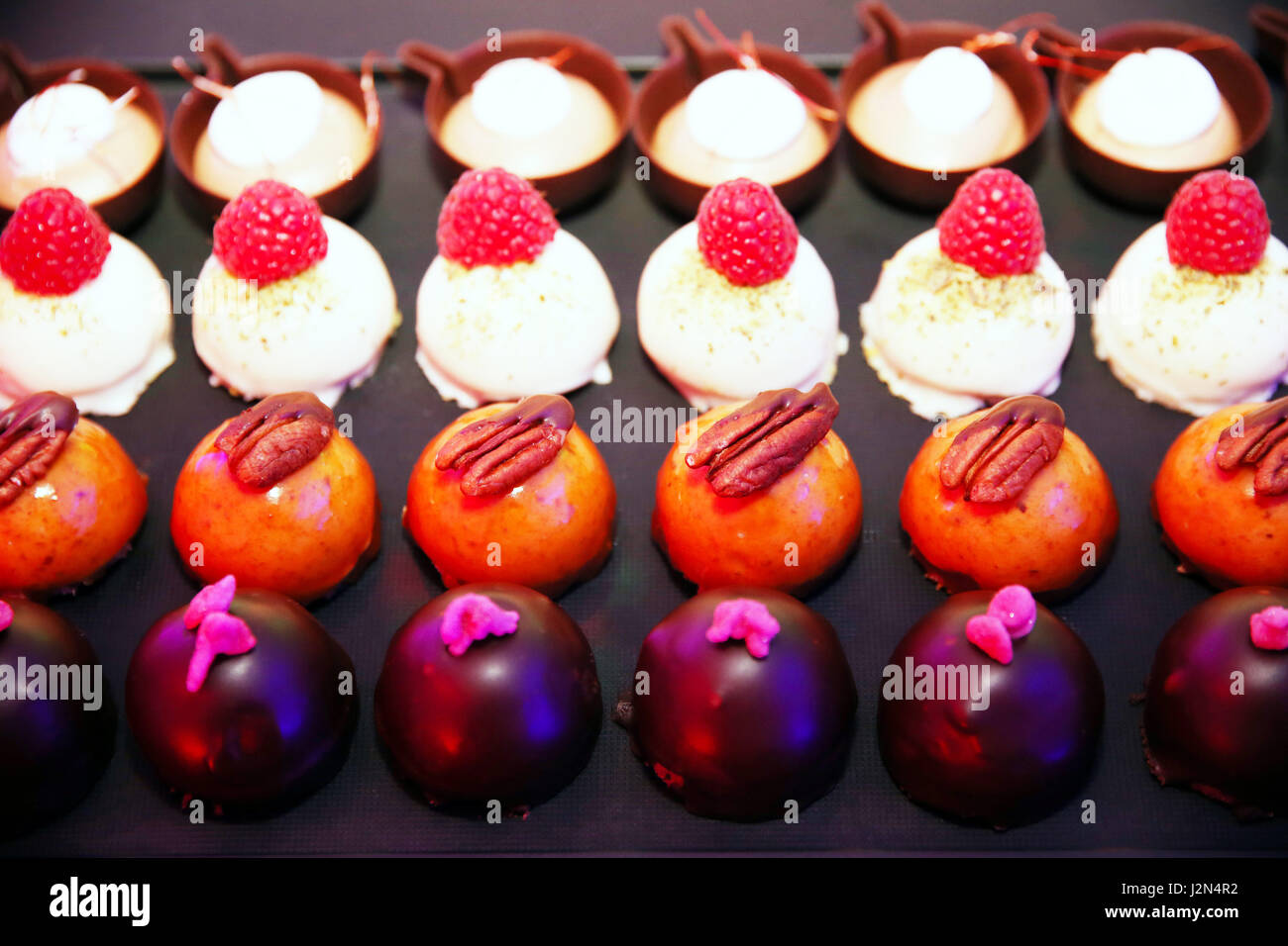 Variety of colorful modern french sweet desserts different fillings ...
