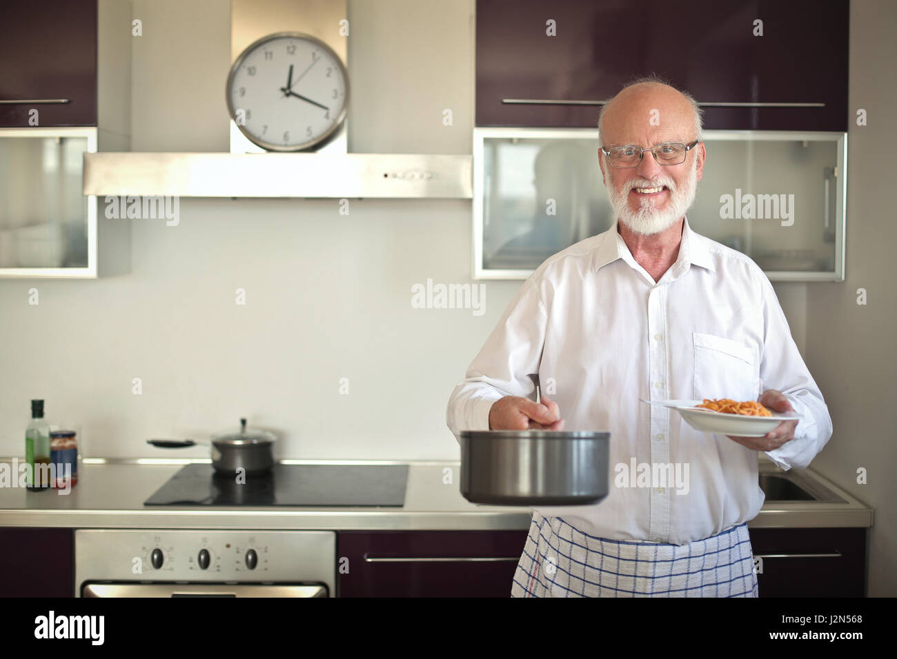 Old man with pot and food in kitchen Stock Photo - Alamy