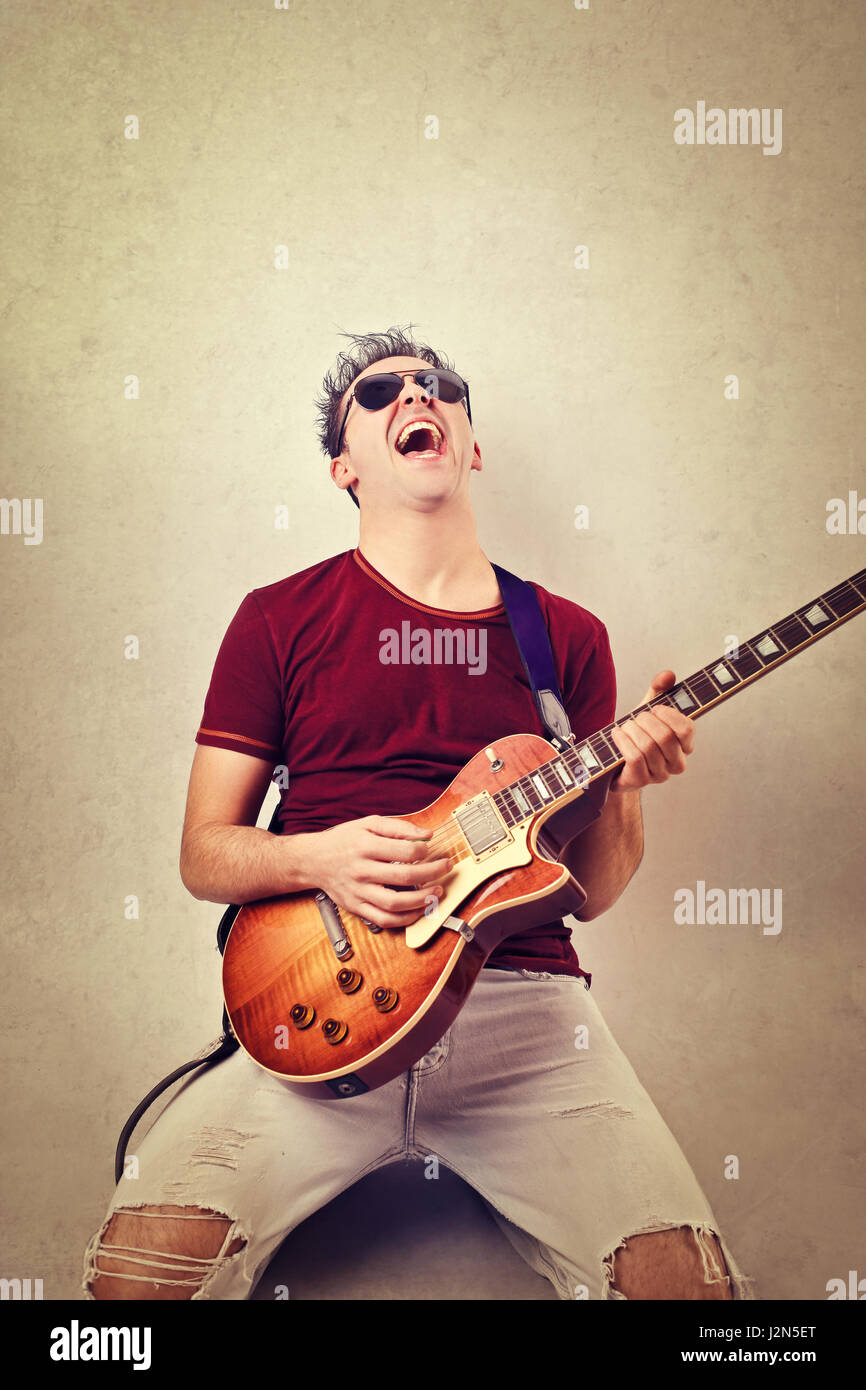 Funny man playing on guitar Stock Photo - Alamy