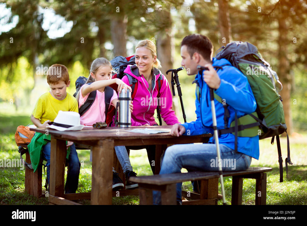 Family have a break from hiking in forest Stock Photo - Alamy