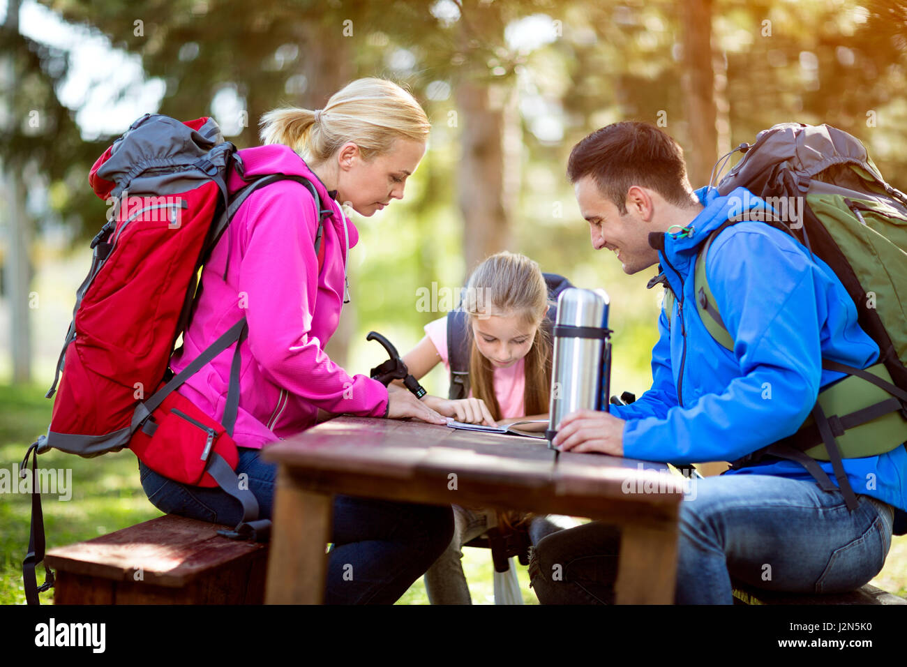 parents and child look map in the forest on hiking Stock Photo - Alamy