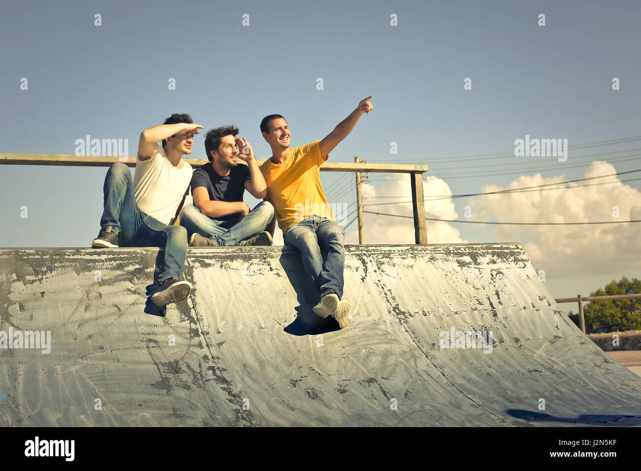 3 men sitting outside Stock Photo - Alamy