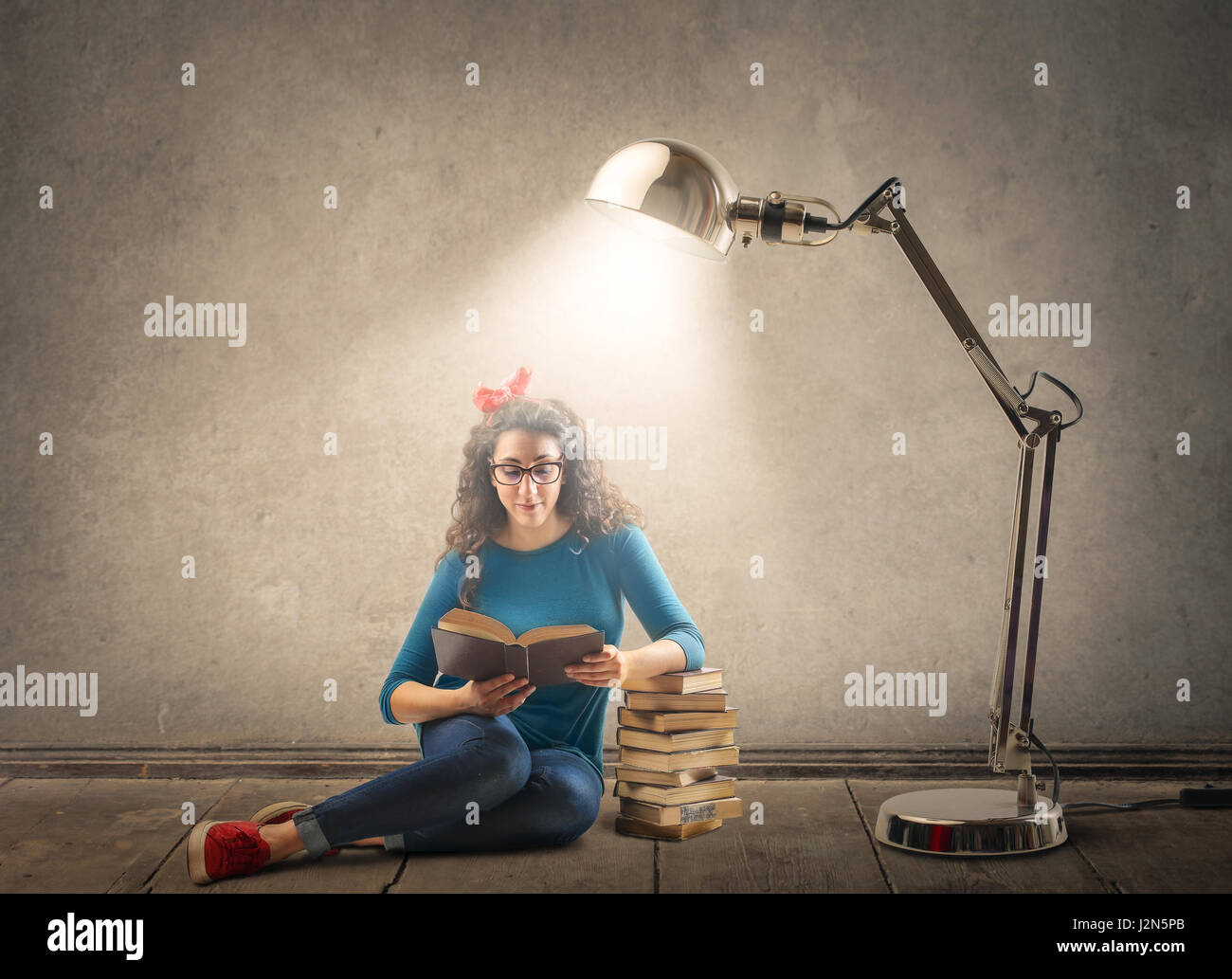 Woman studying under lamp Stock Photo - Alamy