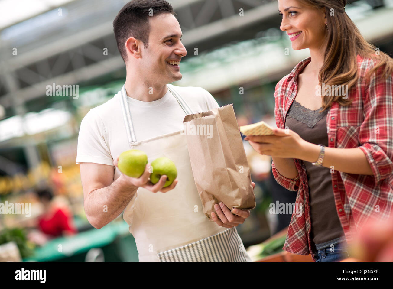 Woman writing check grocery hi-res stock photography and images - Alamy
