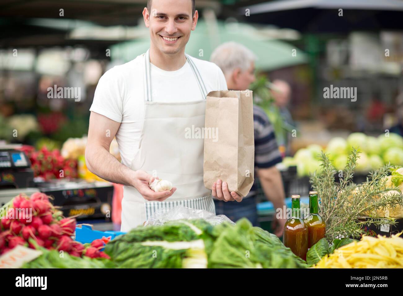 young man standing on stall fresh food at farmer’s market Stock Photo ...
