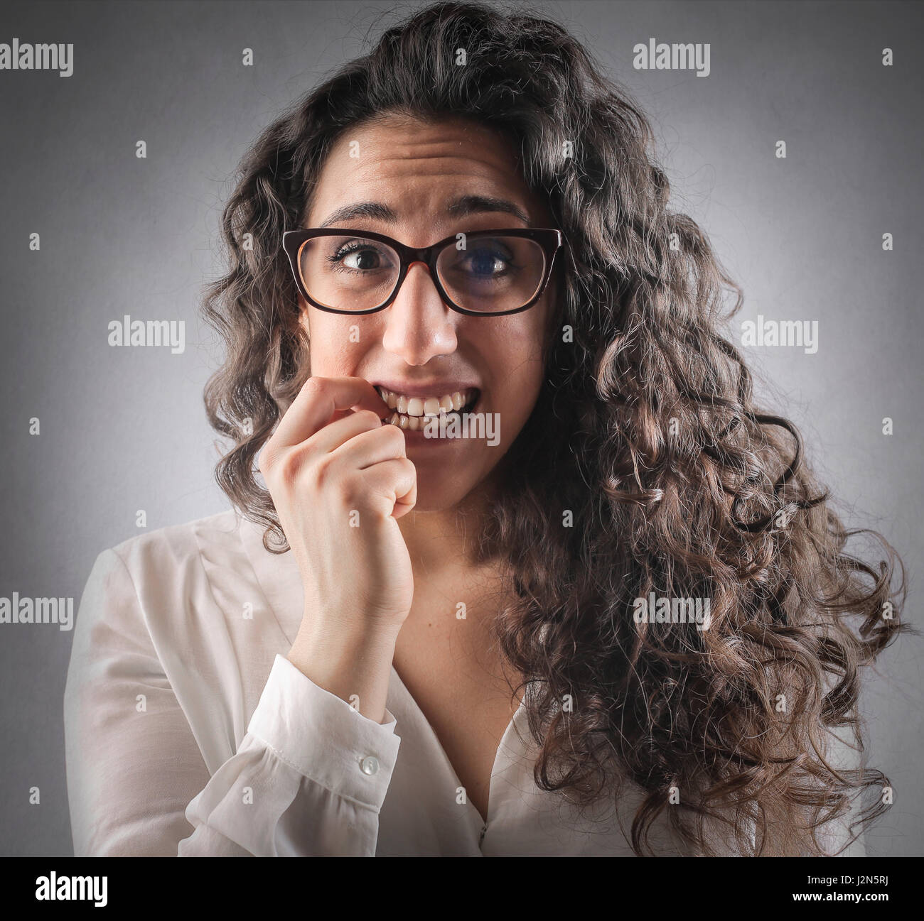 Nervous woman in glasses Stock Photo - Alamy