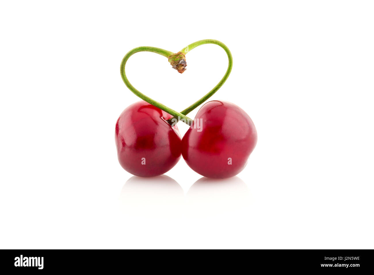 cherry heart isolated on white Stock Photo - Alamy