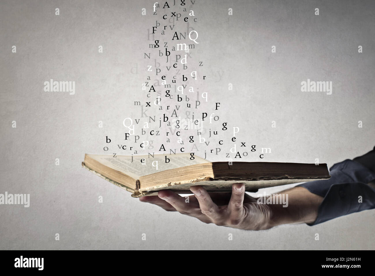 Book with letters coming out of it Stock Photo - Alamy