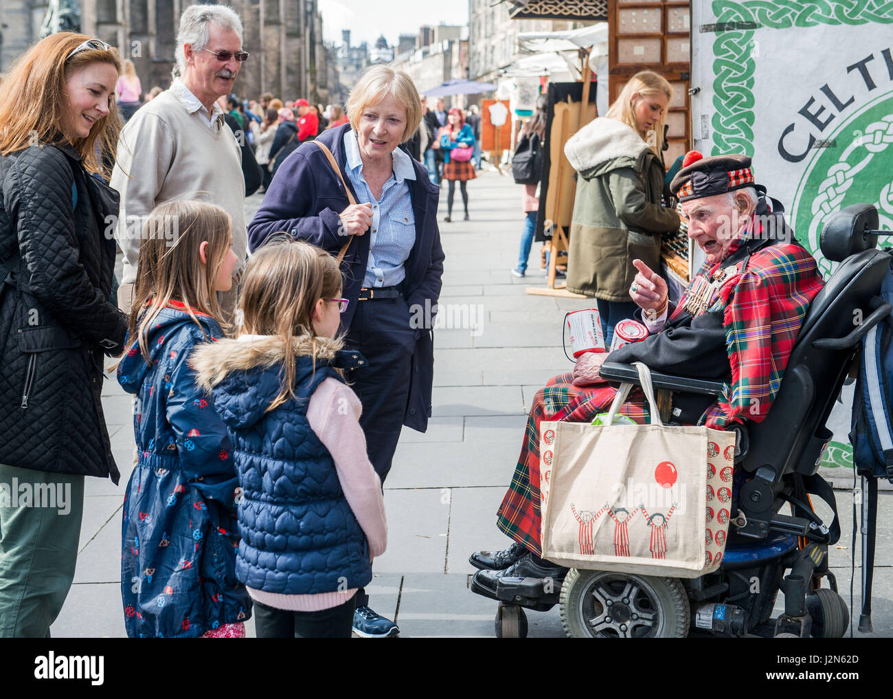 Tom Gilzean collecting on the Royal Mile Stock Photo - Alamy