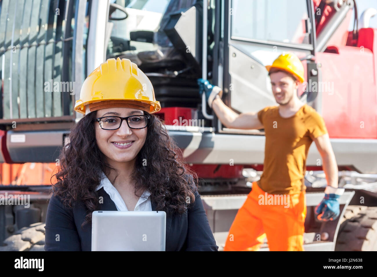 young female engineer posing in junkyard with a worker Stock Photo - Alamy