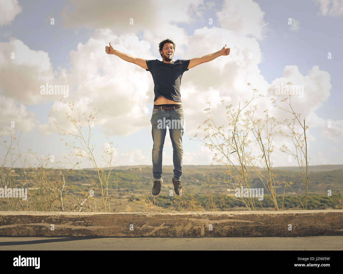 Man jumping on field Stock Photo - Alamy