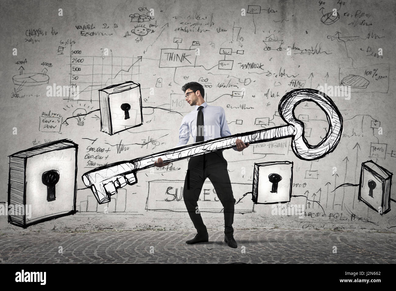 Businessman holding huge illustrated key Stock Photo - Alamy