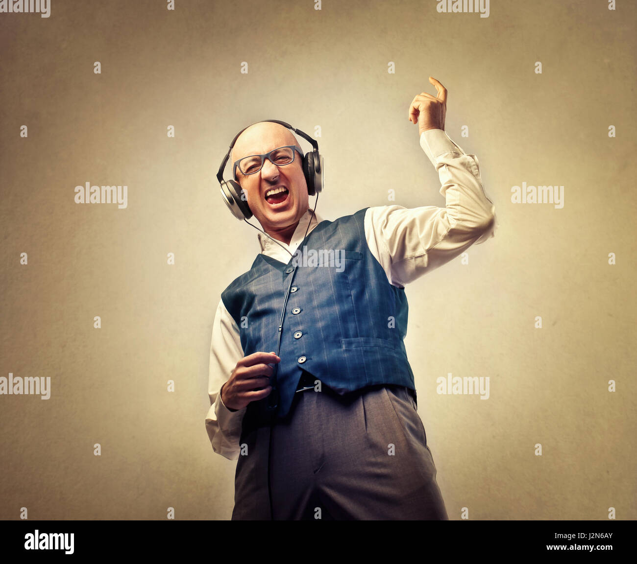 Bald man dancing to music Stock Photo - Alamy