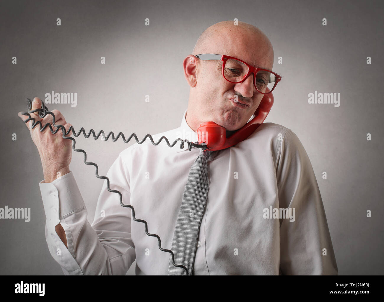 Bald businessman talking on phone Stock Photo - Alamy