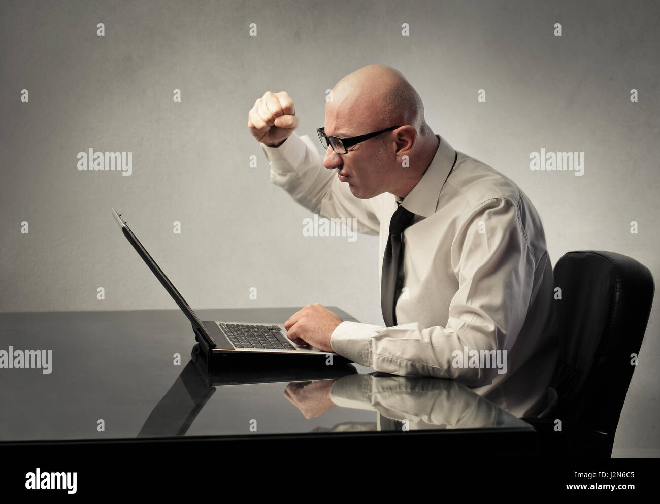 Bald businessman working on laptop Stock Photo - Alamy