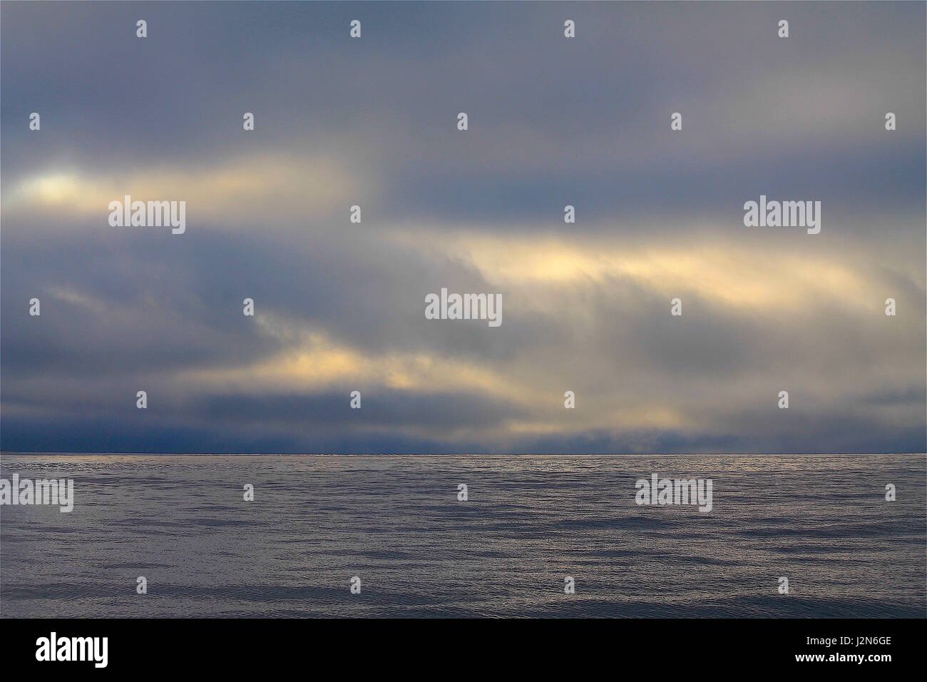 Overcast sunset at sea Stock Photo - Alamy