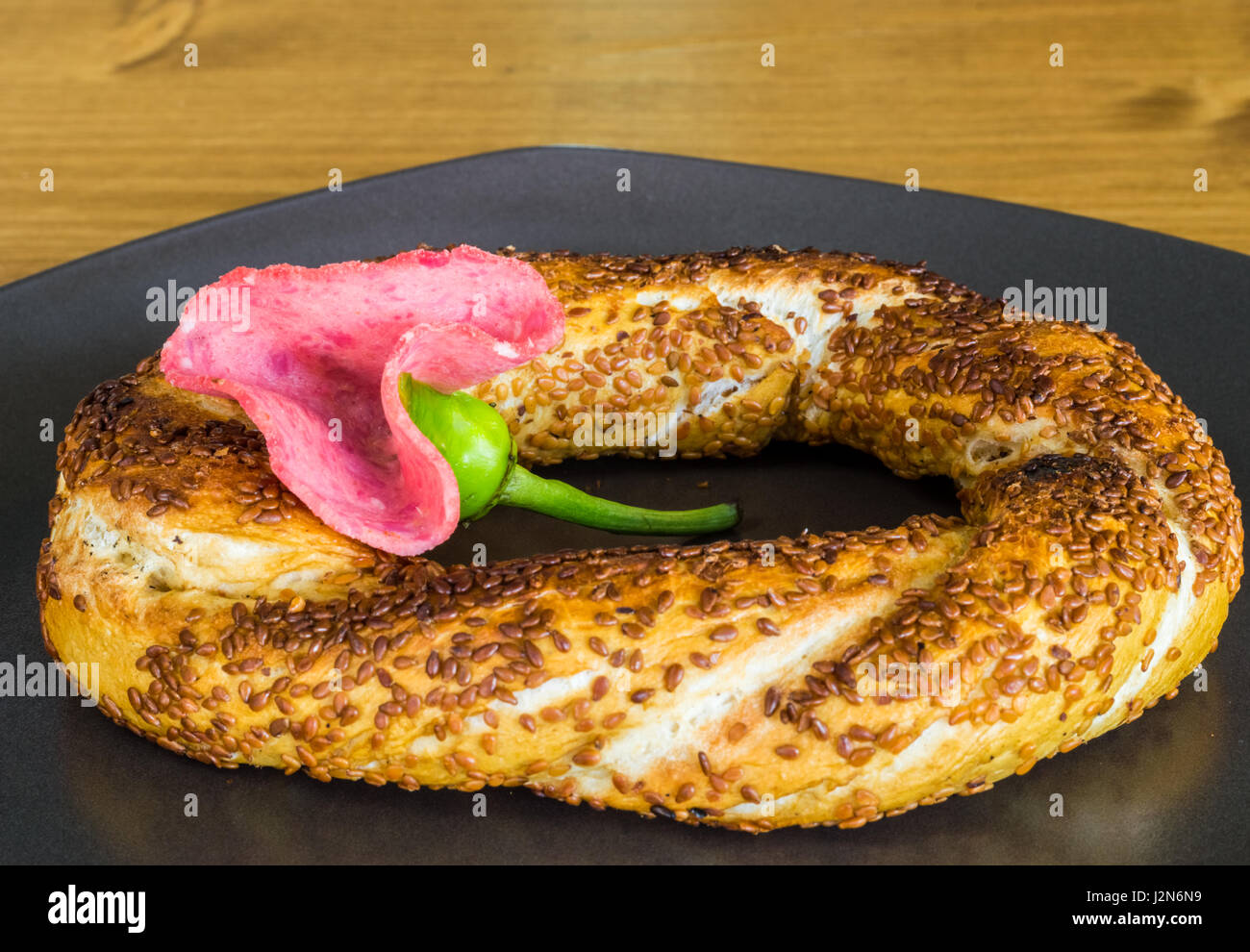Closeup of traditional Turkish Pastry (Simit) with salami served on a ...