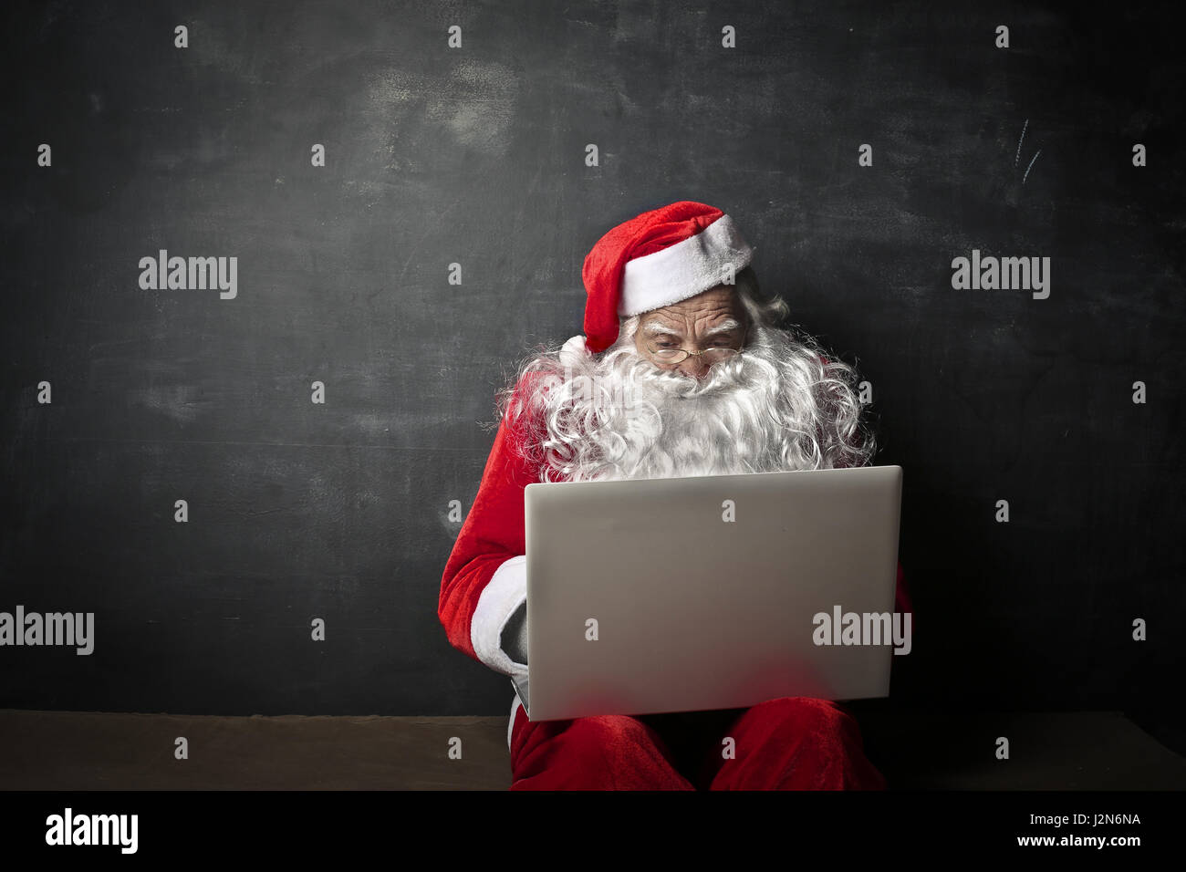 Santa Claus with laptop Stock Photo - Alamy