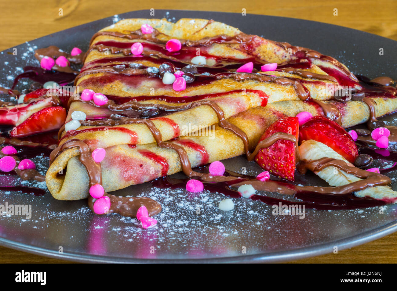 Closeup of crepe with chocolate cream, chocolate chips, banana and ...