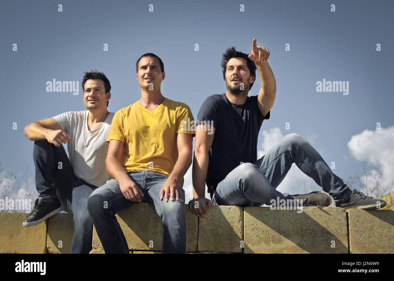 3 men sitting outside Stock Photo - Alamy
