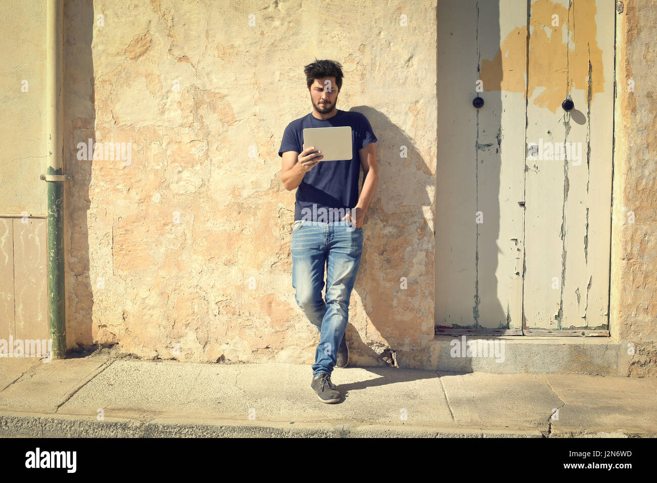 Man standing with tablet Stock Photo - Alamy