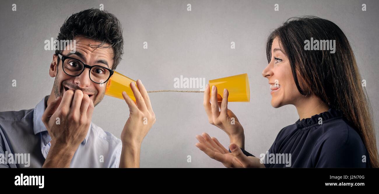 Woman and man talking with paper glasses Stock Photo - Alamy