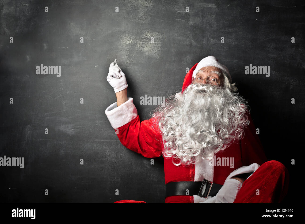 Santa Claus next to chalkboard Stock Photo - Alamy