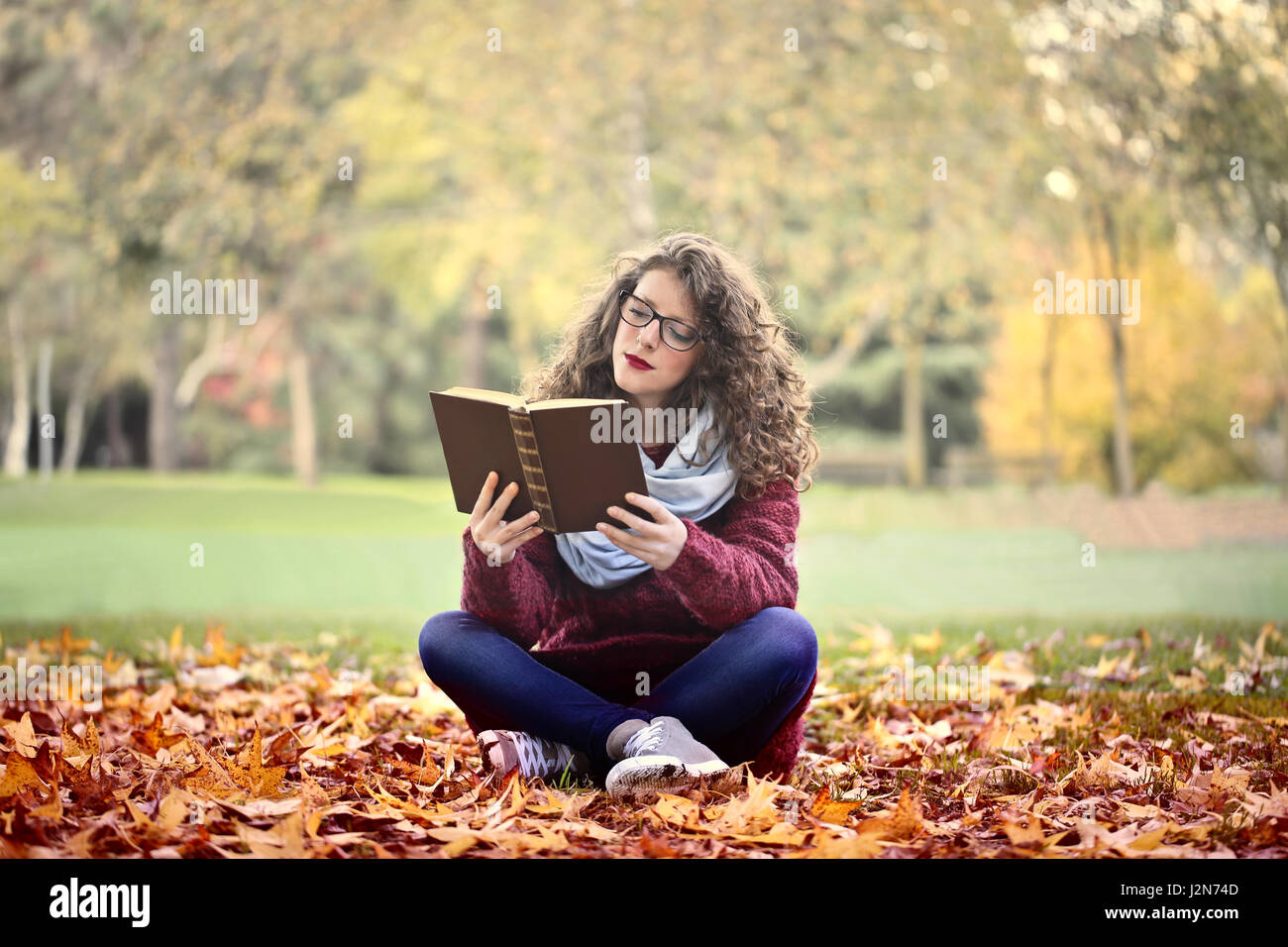 Woman reading in the nature Stock Photo - Alamy