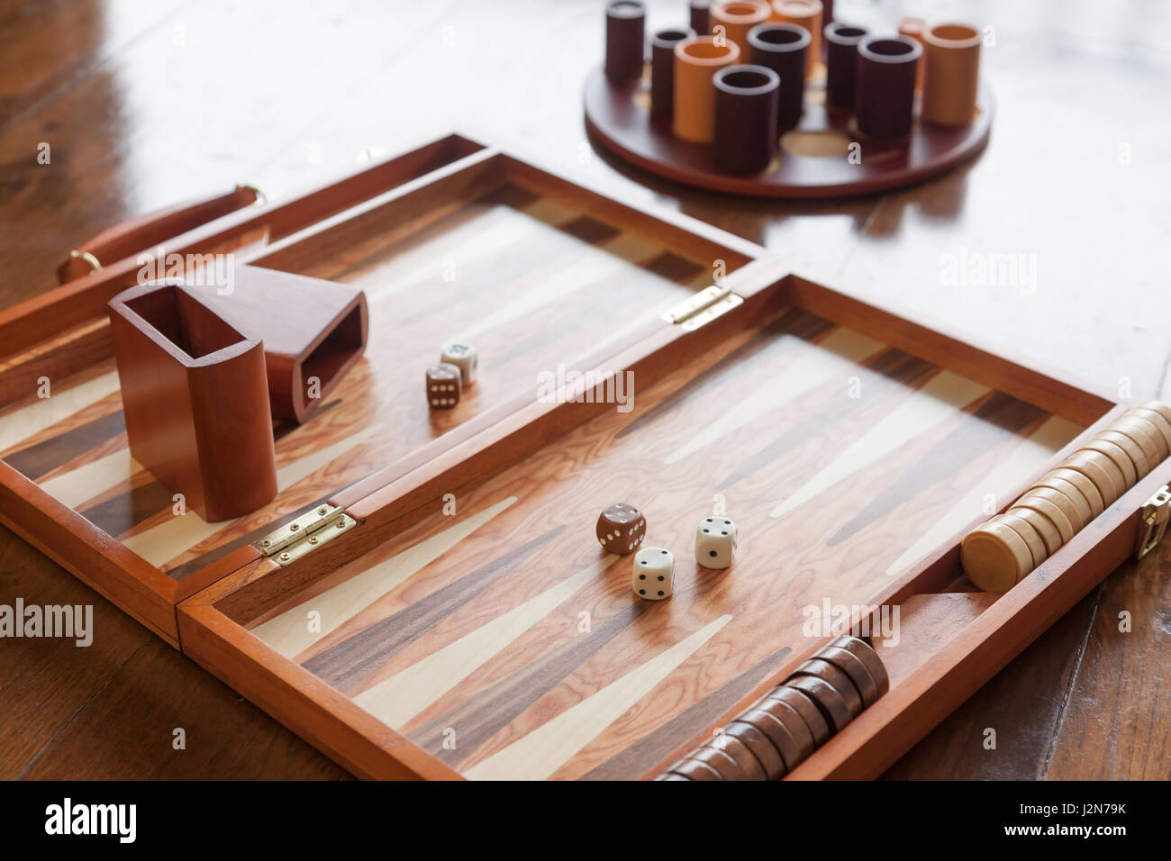 Wooden backgammon game set on wooden floor, selective focus on the two ...