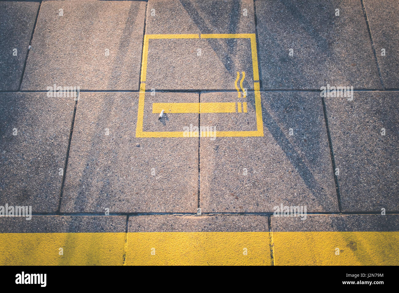 cigarette and smoking area symbol on floor Stock Photo - Alamy