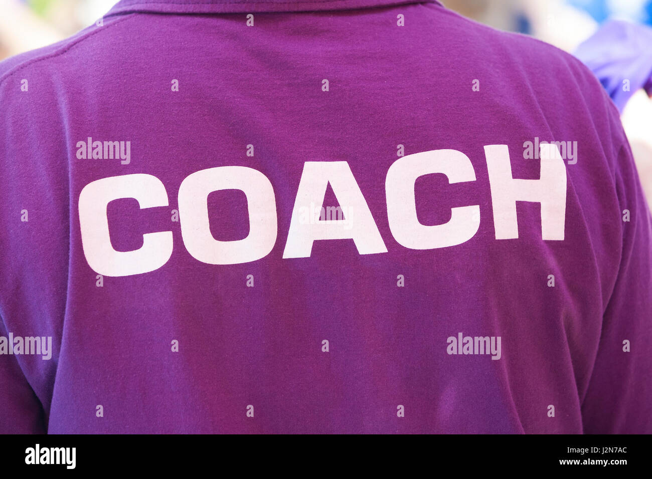 Back of a coach's shirt with white word coach printed on Stock Photo ...