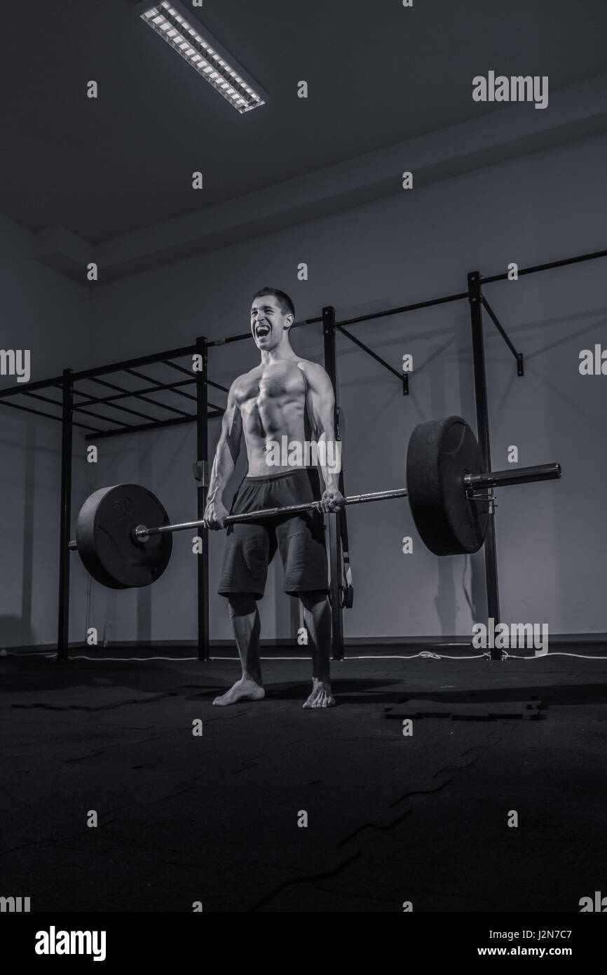 one young man only, bodybuilder deadlift, shouting screaming, weights ...