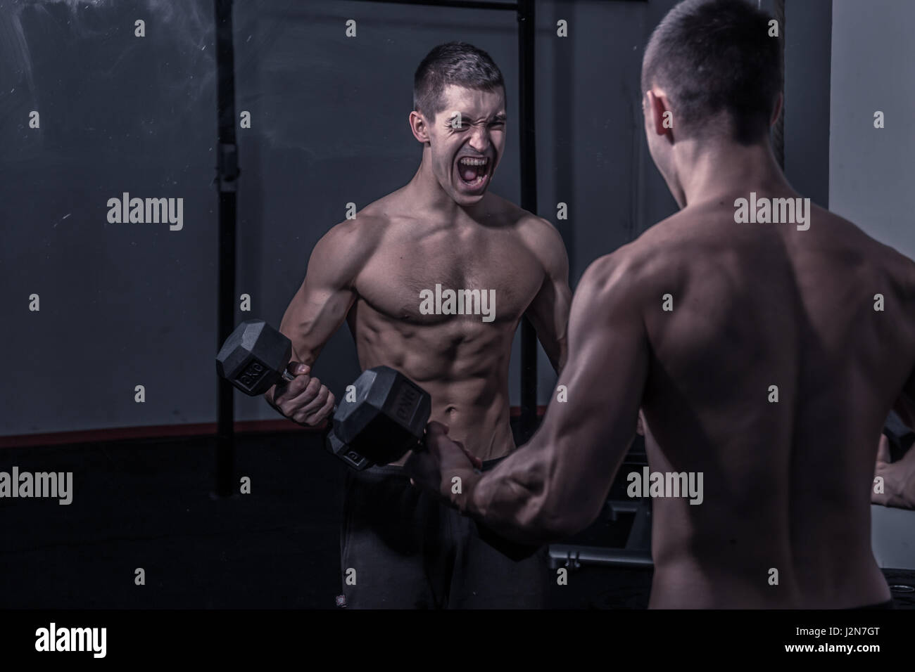 one young man, shouting screaming, looking at himself, mirror, holding ...