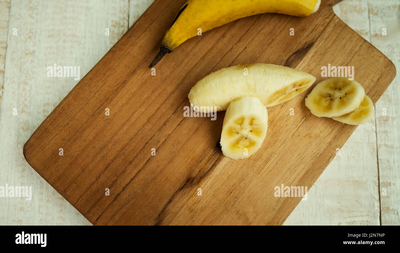 Fresh banana on cutting board, sliced banana on wooden board Stock ...