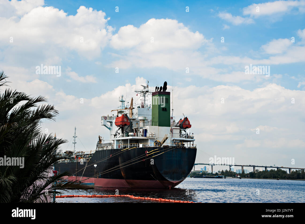 Logistic concept, black Ship parked in the river. Waiting to dock and ...