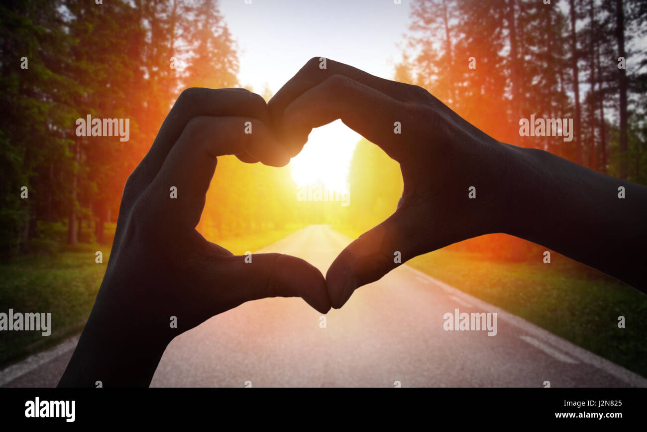 Cropped Hand Making Heart Shape and a empty road Stock Photo - Alamy