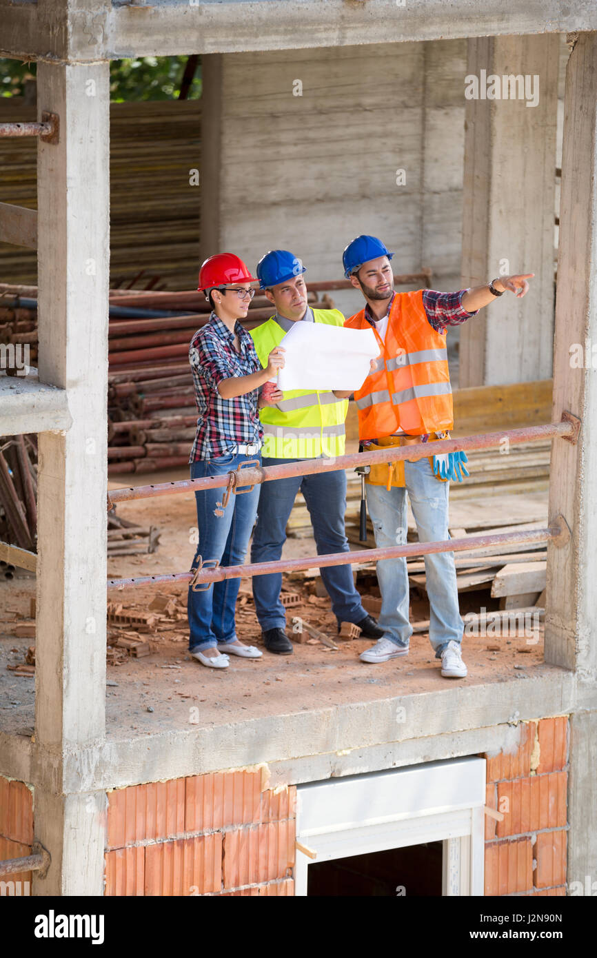 Group of architects discussing and planning future building on ...