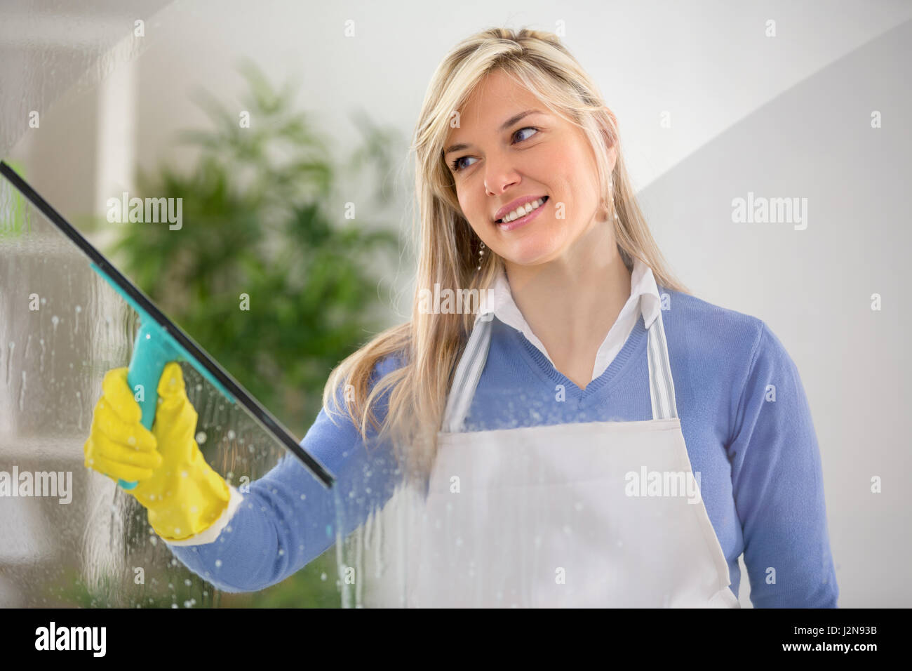 Young woman clean window Stock Photo - Alamy