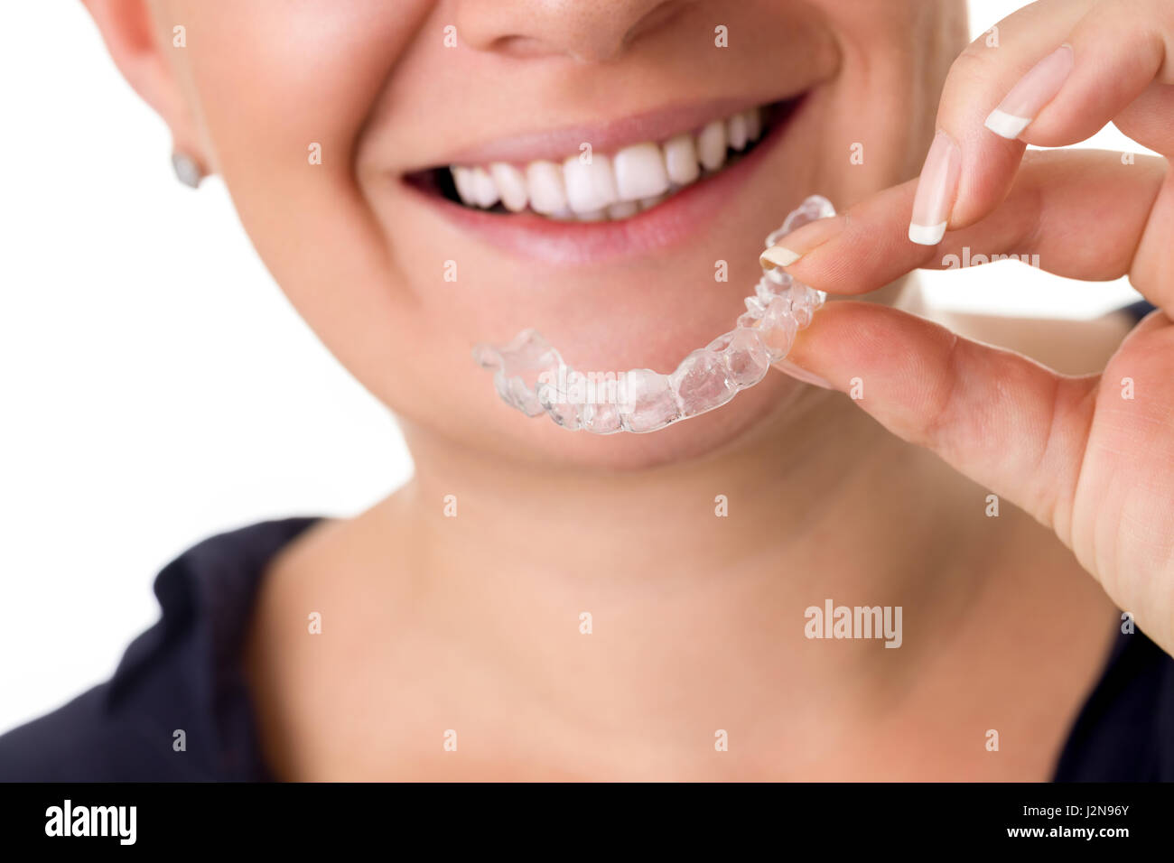 Woman with perfect teeth holding invisible braces, correction teeth ...