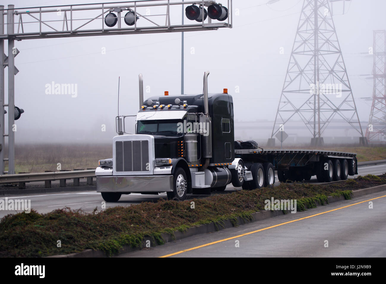 Stylish classic semi truck with chrome body trim and a flat bed trailer ...