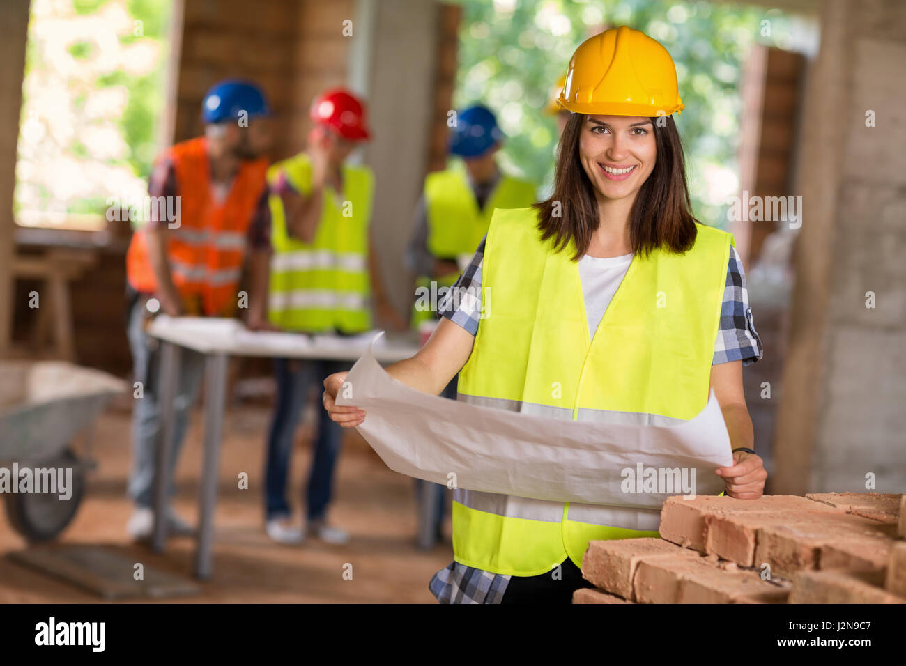 Female student of architecture on practice hold construction plan in ...